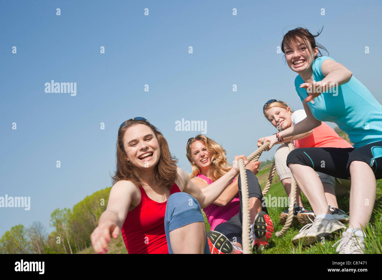 Young Women Pulling on Rope Stock Photo - Alamy
