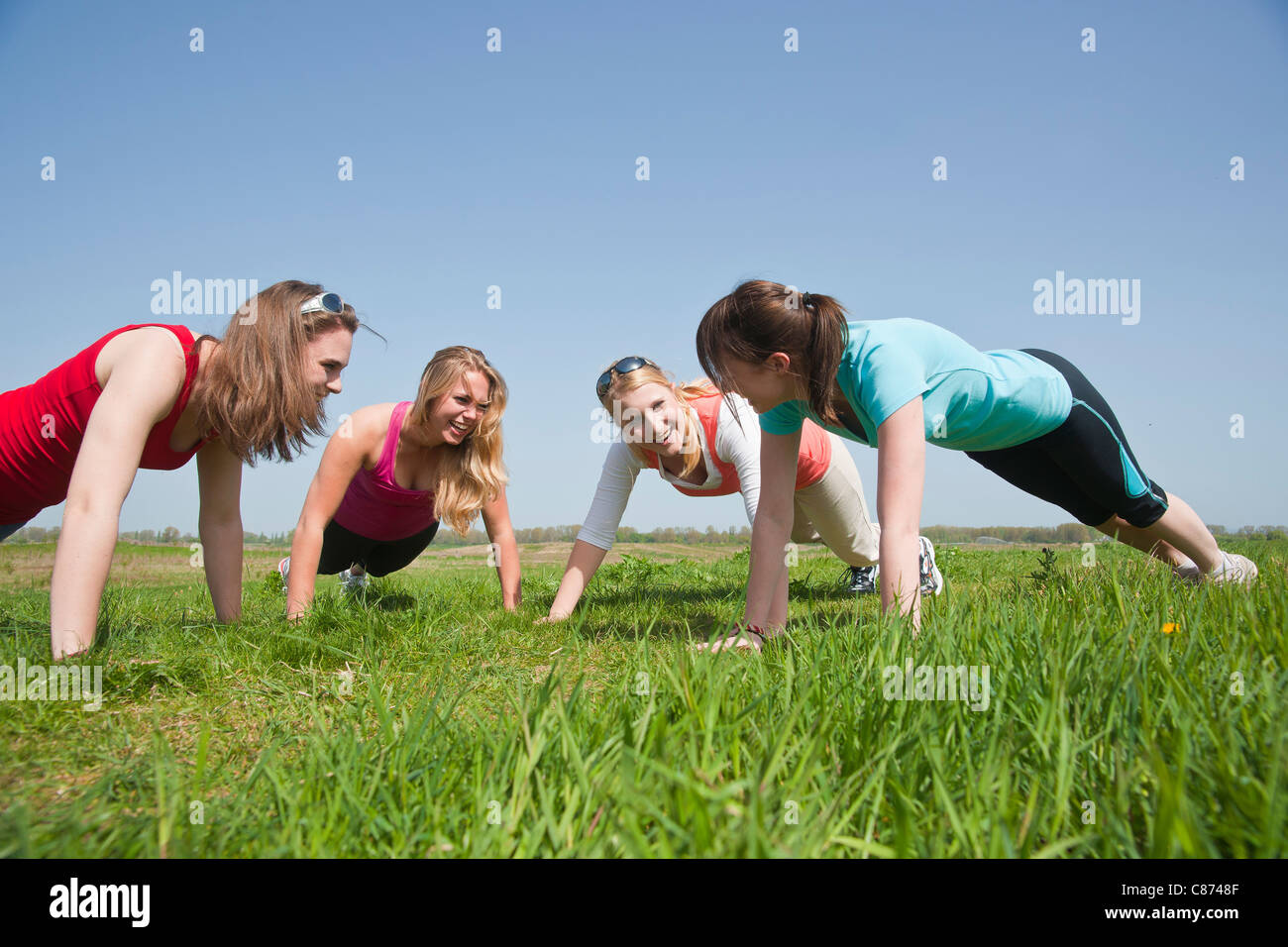 Young Women Doing Push-Ups Stock Photo - Alamy