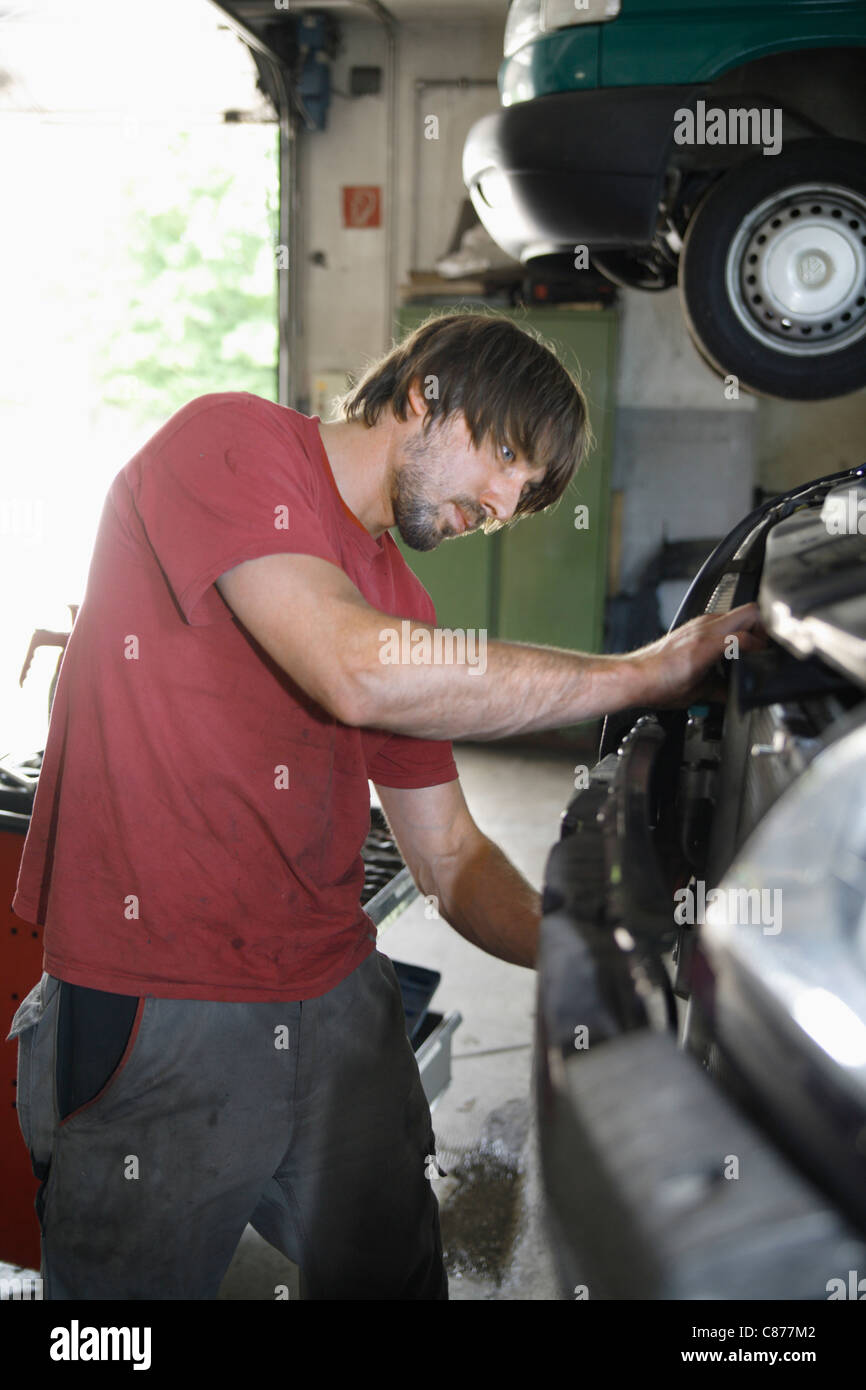 Germany, Ebenhausen, Mechatronic technician working in car garage Stock ...