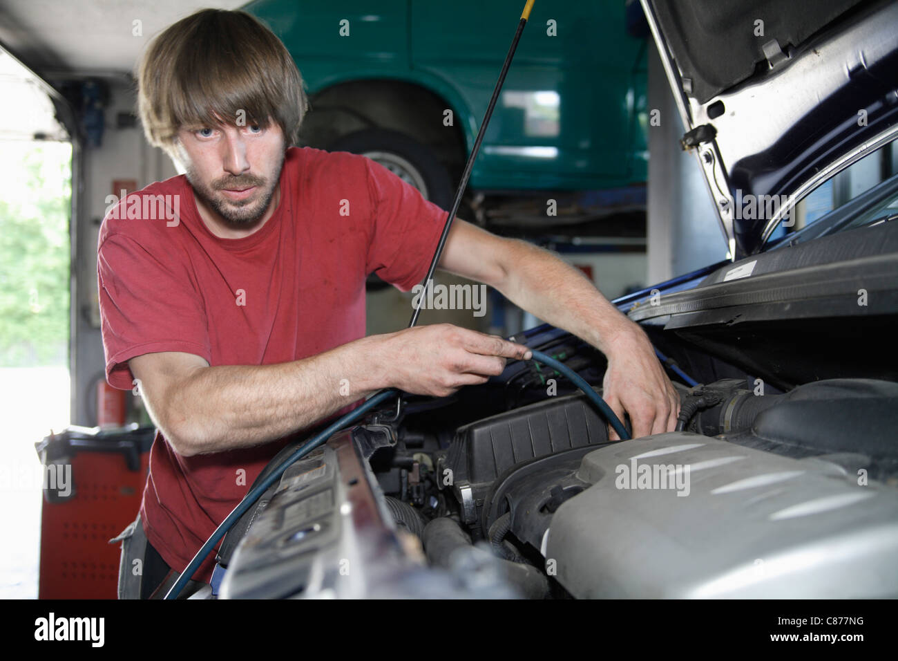 Germany, Ebenhausen, Mechatronic technician working in car garage Stock ...