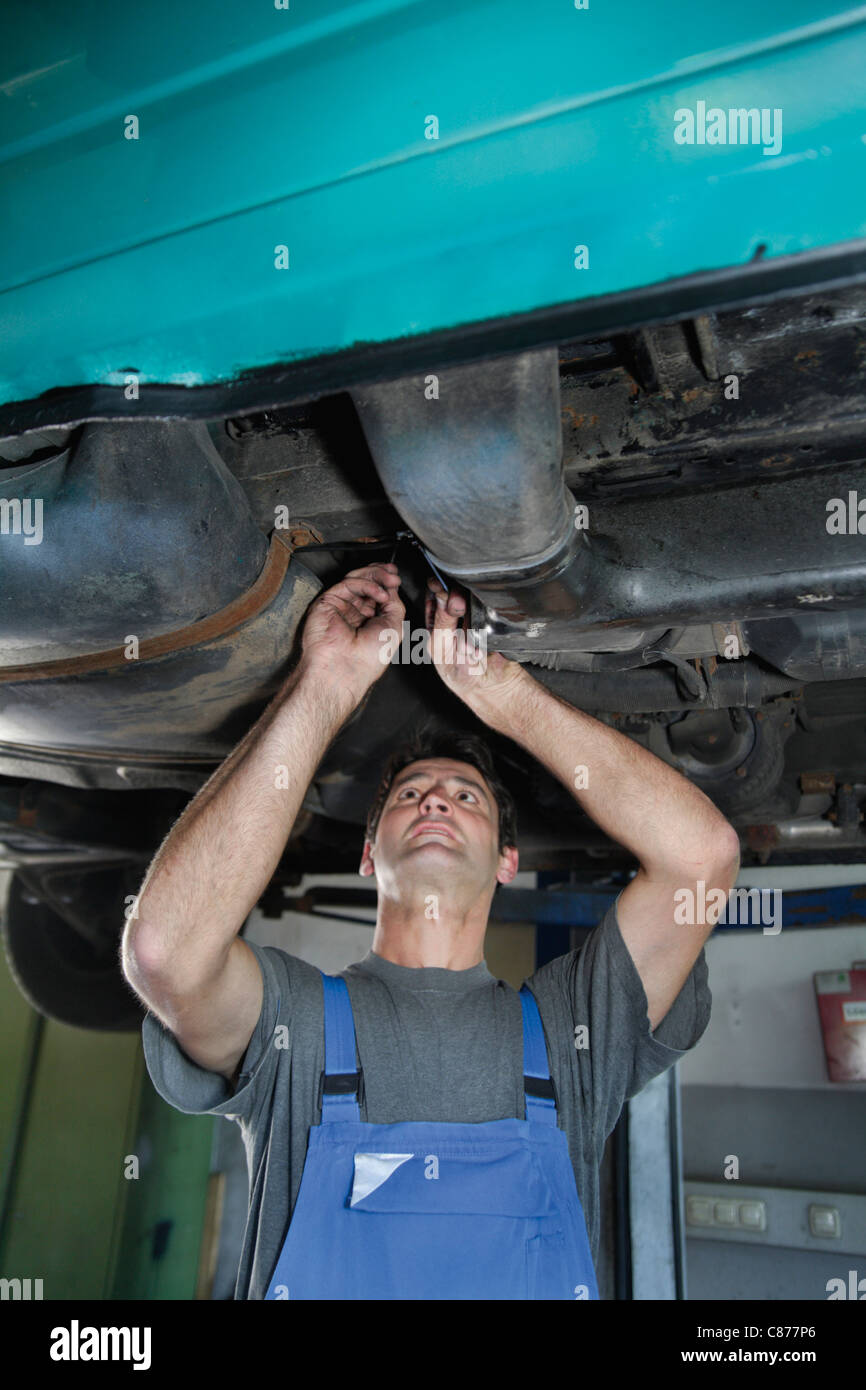 Germany, Ebenhausen, Mechatronic technician working in car garage Stock ...