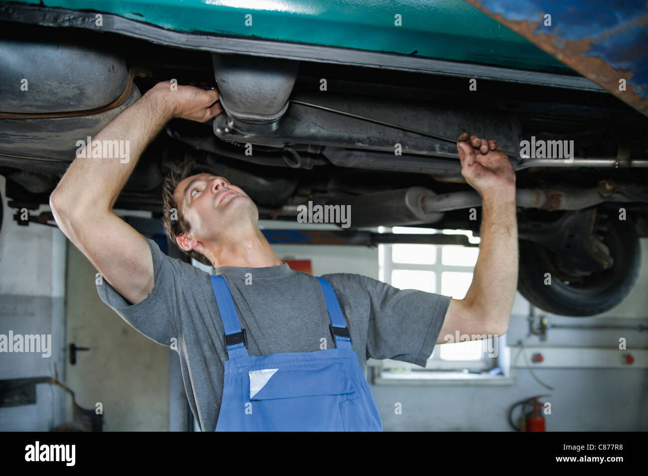 Germany, Ebenhausen, Mechatronic technician working in car garage Stock ...
