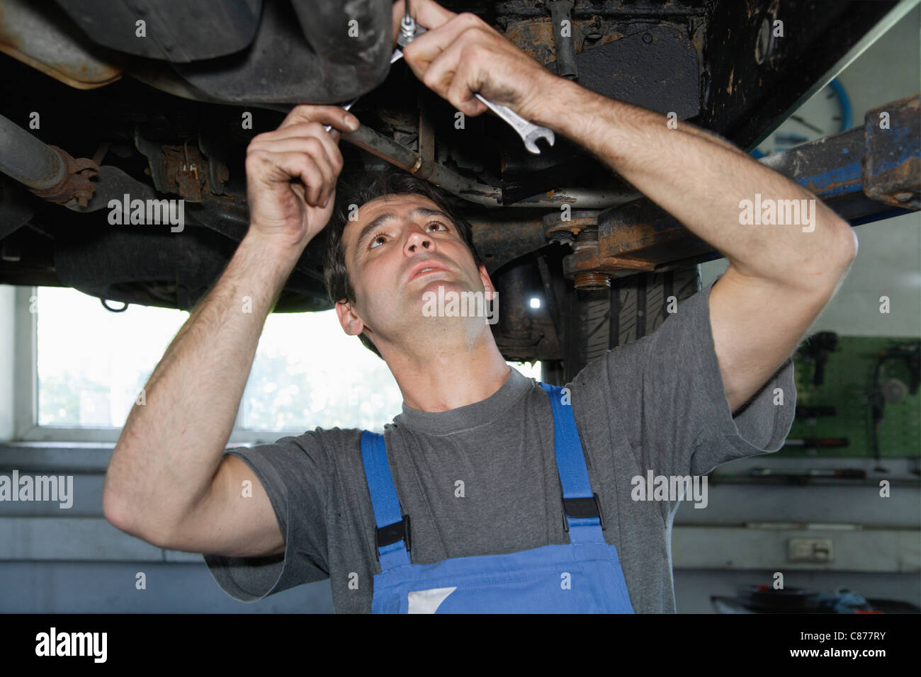 Germany, Ebenhausen, Mechatronic technician working in car garage Stock ...