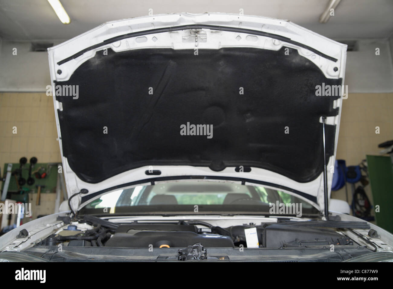 Germany, Ebenhausen, Open car bonnet in repair garage Stock Photo - Alamy