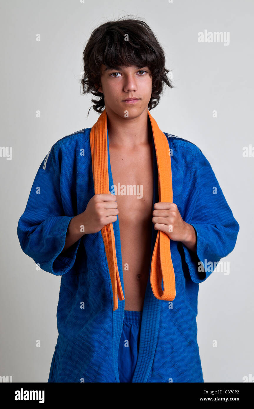 Young fighter posing against a light background Stock Photo - Alamy