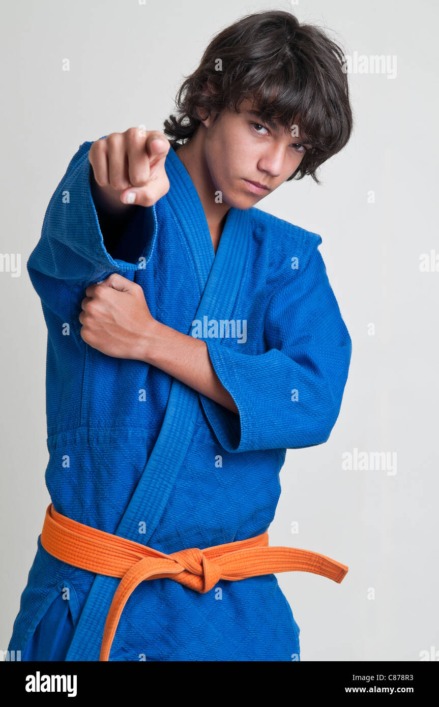 Young fighter posing against a light background Stock Photo - Alamy