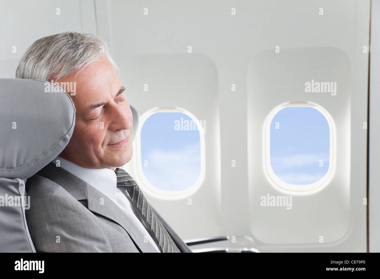 Germany, Bavaria, Munich, Senior businessman sleeping in business class ...