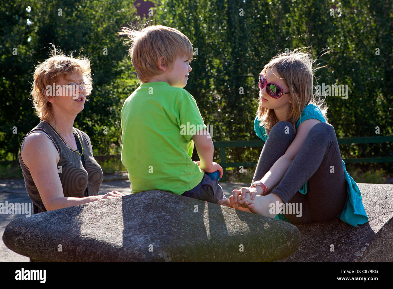 young family having a break in a park Stock Photo - Alamy