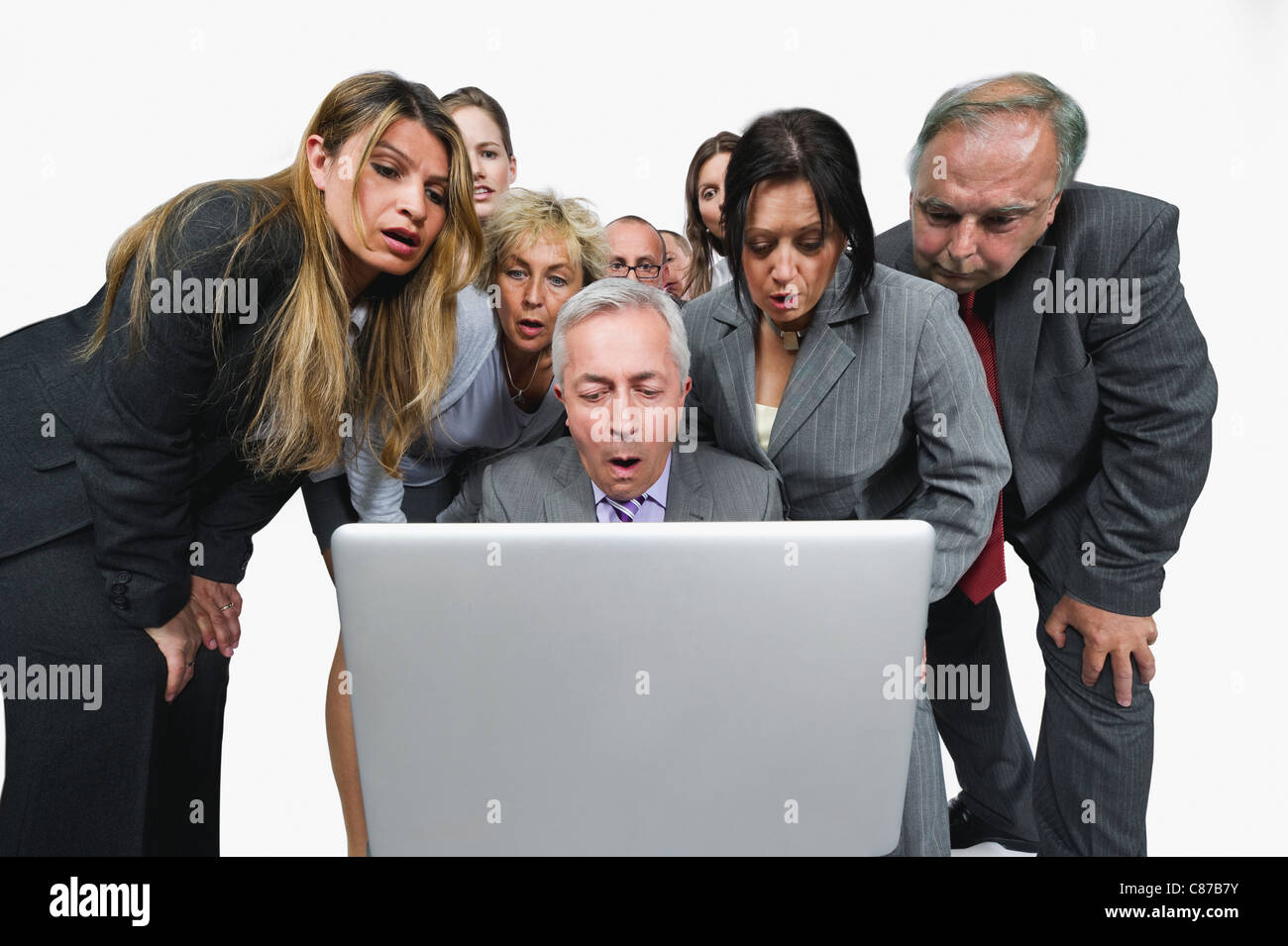 Business people looking at laptop against white background Stock Photo ...