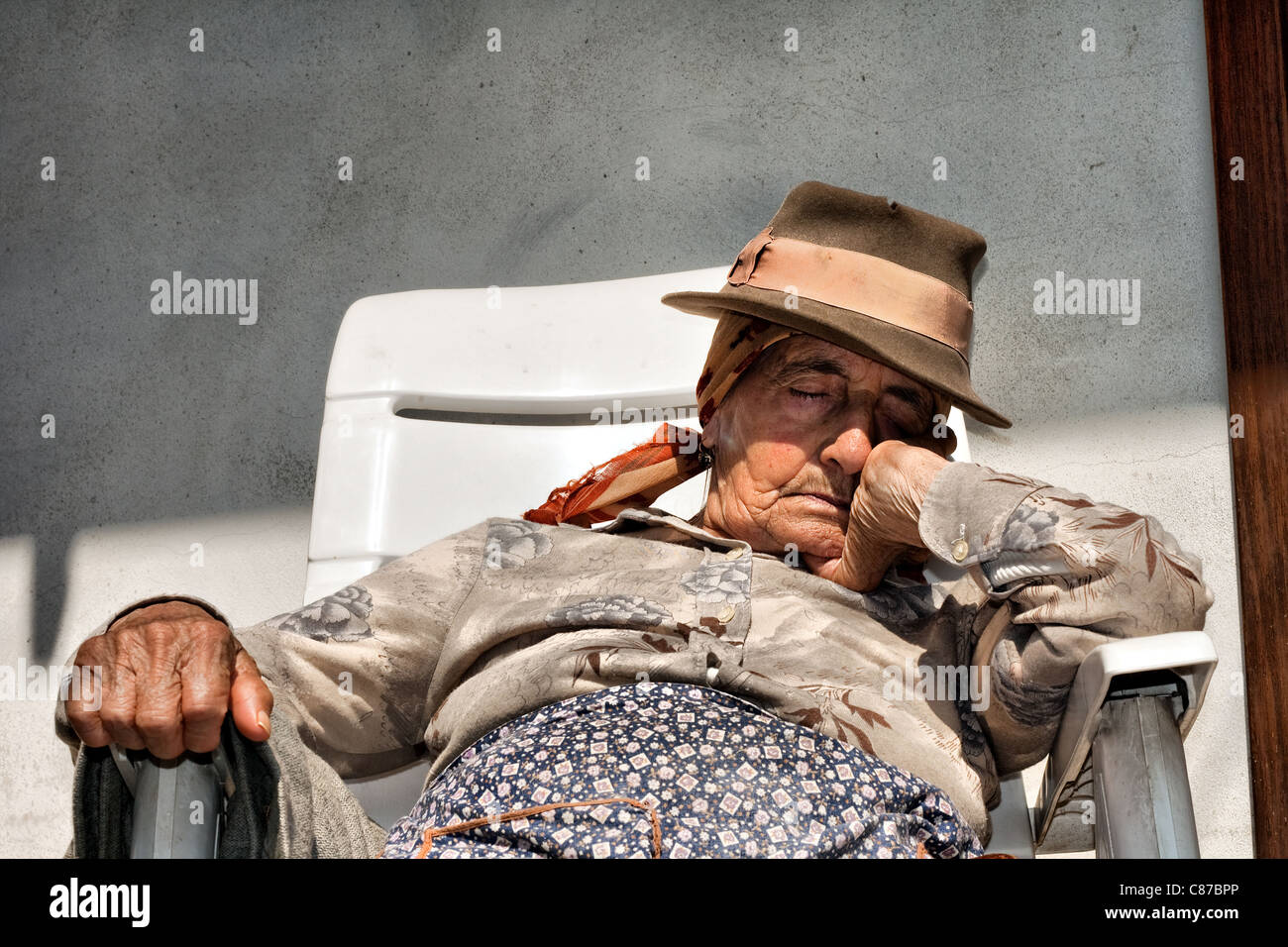 A senior woman reclining in a lounge chair Stock Photo - Alamy