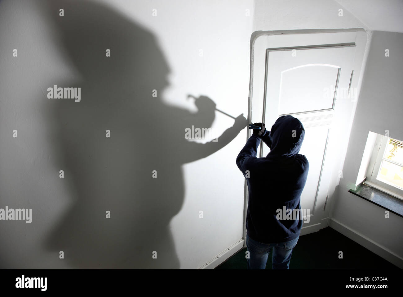 Burglar in a private house. Daylight burglary. Breaking into a house ...