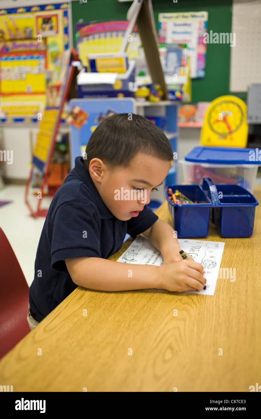 Preschool boy at table in classroom Stock Photo - Alamy