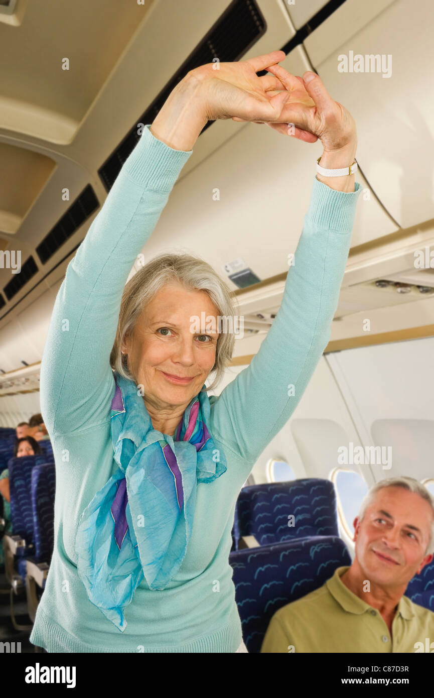 Aeroplane passenger stretching hi-res stock photography and images - Alamy