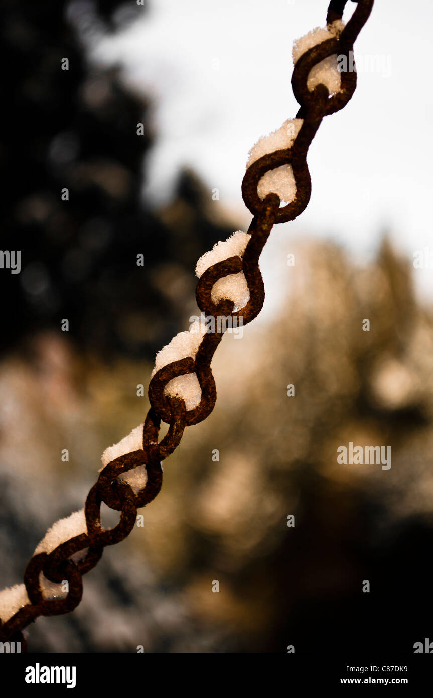 Snow covered rusty metal chain Stock Photo - Alamy