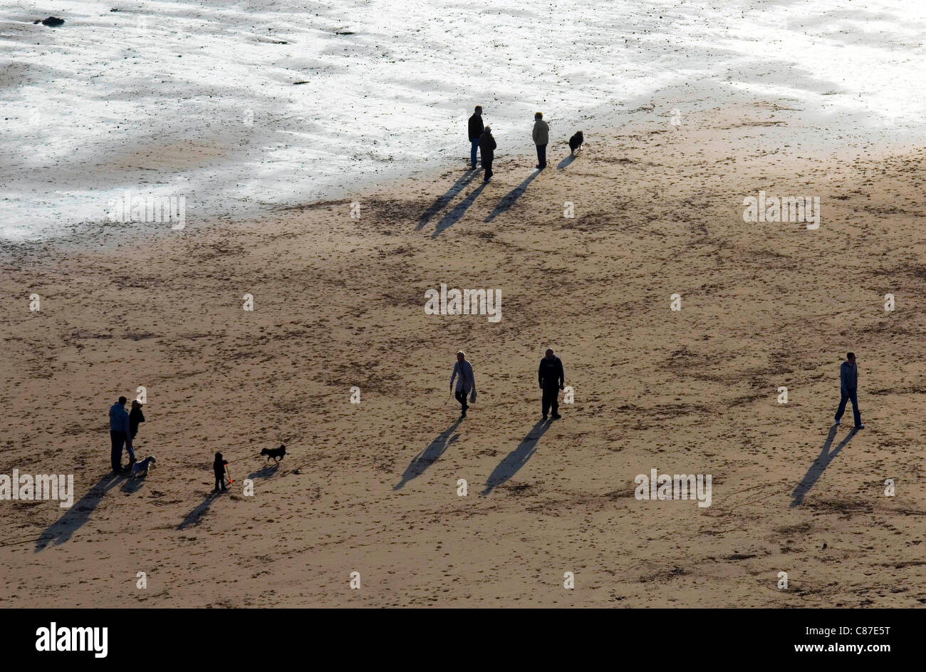 People making the most of the late afternoon sunshine at Langland Bay ...
