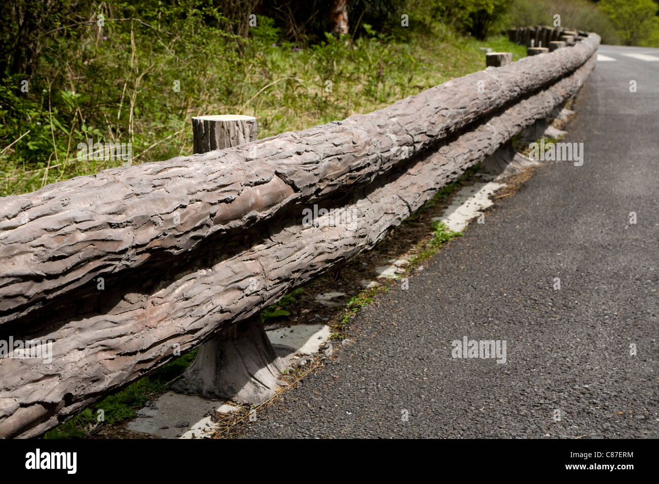 Disguised (to make less obtrusive) crash barrier / barriers on a road ...