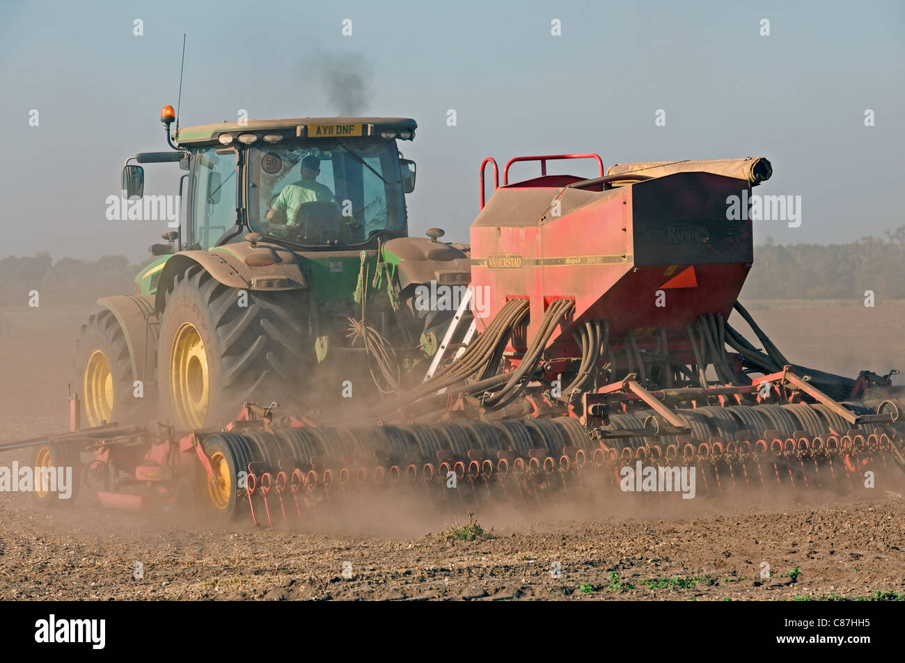 Barley being sewn on a dry and dusty field, Sutton, Suffolk, UK Stock ...