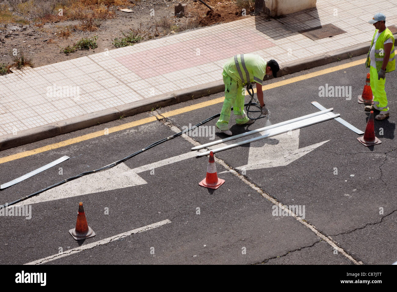 Repainting faded road markings Stock Photo - Alamy
