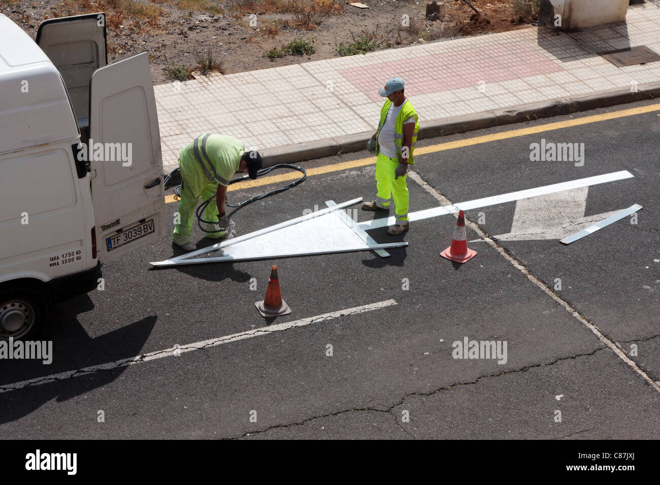 Repainting faded road markings Stock Photo - Alamy