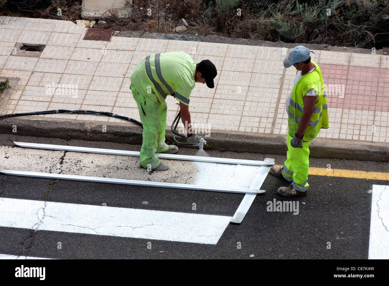 Repainting faded road markings Stock Photo - Alamy