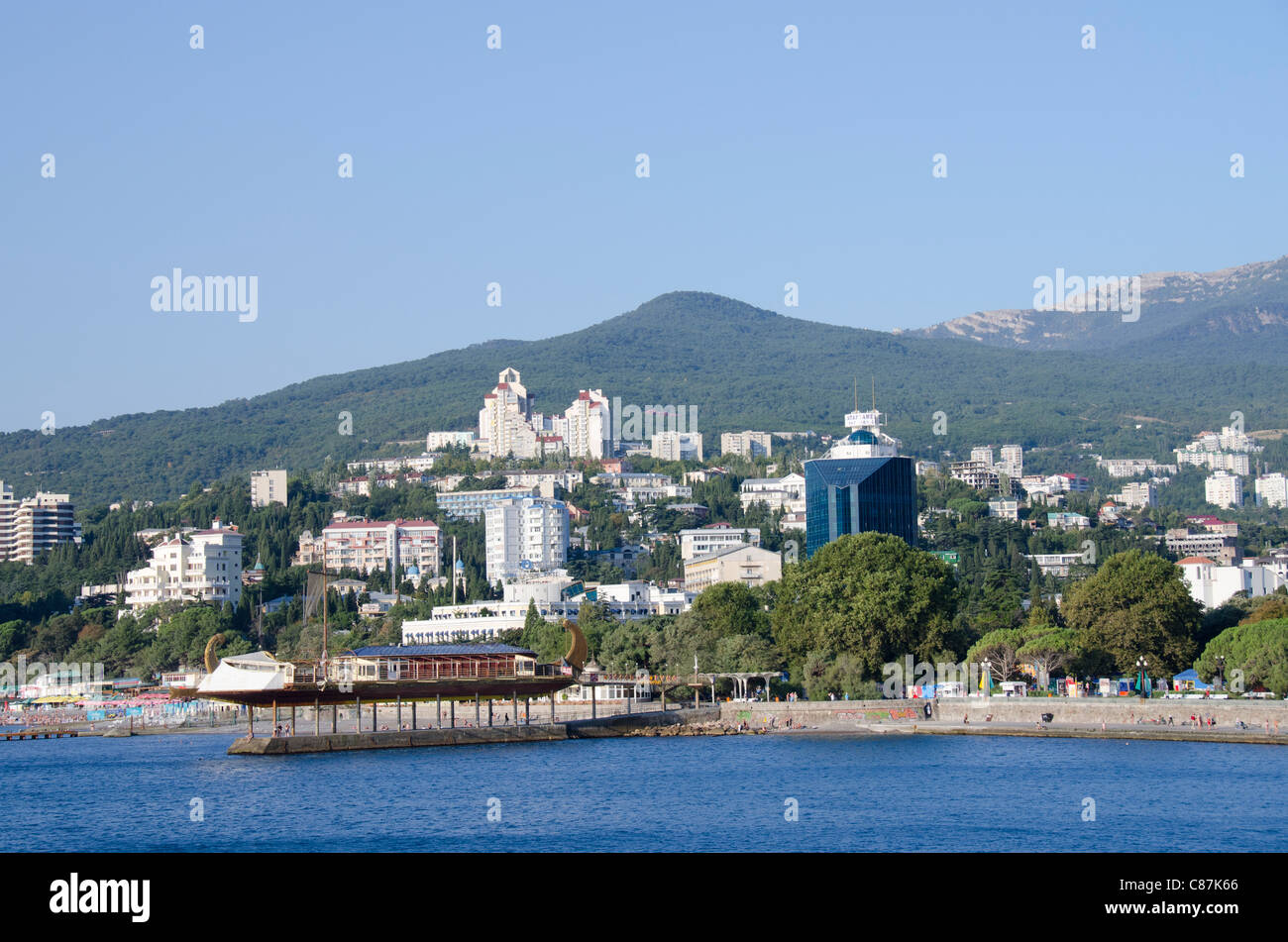 Ukraine, Yalta. Black Sea view of the port of Yalta with the Crimean ...