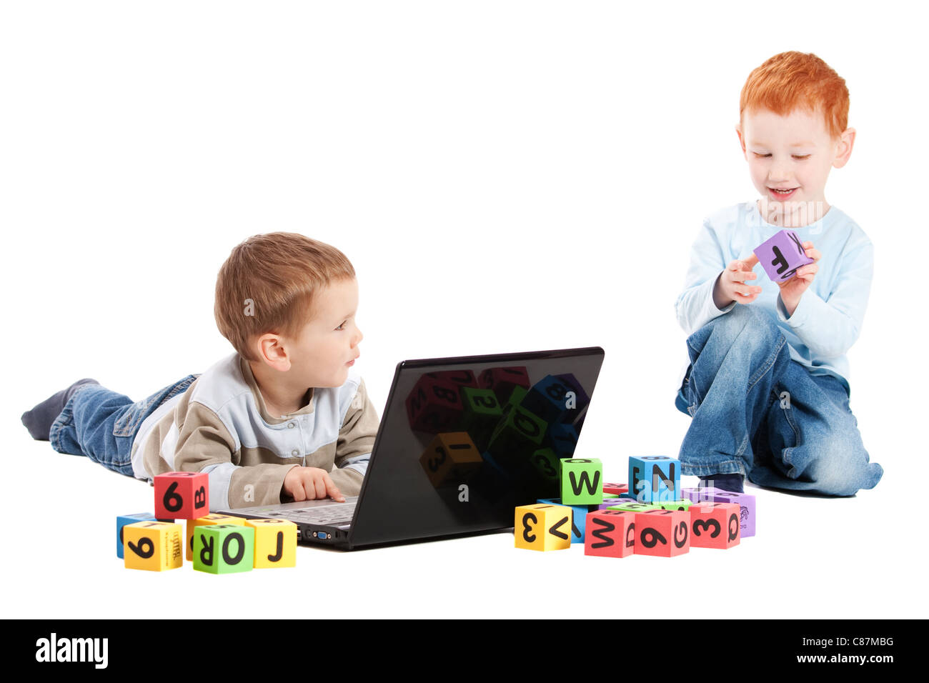 Boys with computer and blocks. Isolated on whaite Stock Photo - Alamy