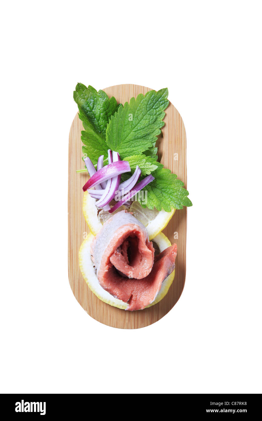 Matjes herring fillet with slices of lemon and onion Stock Photo - Alamy