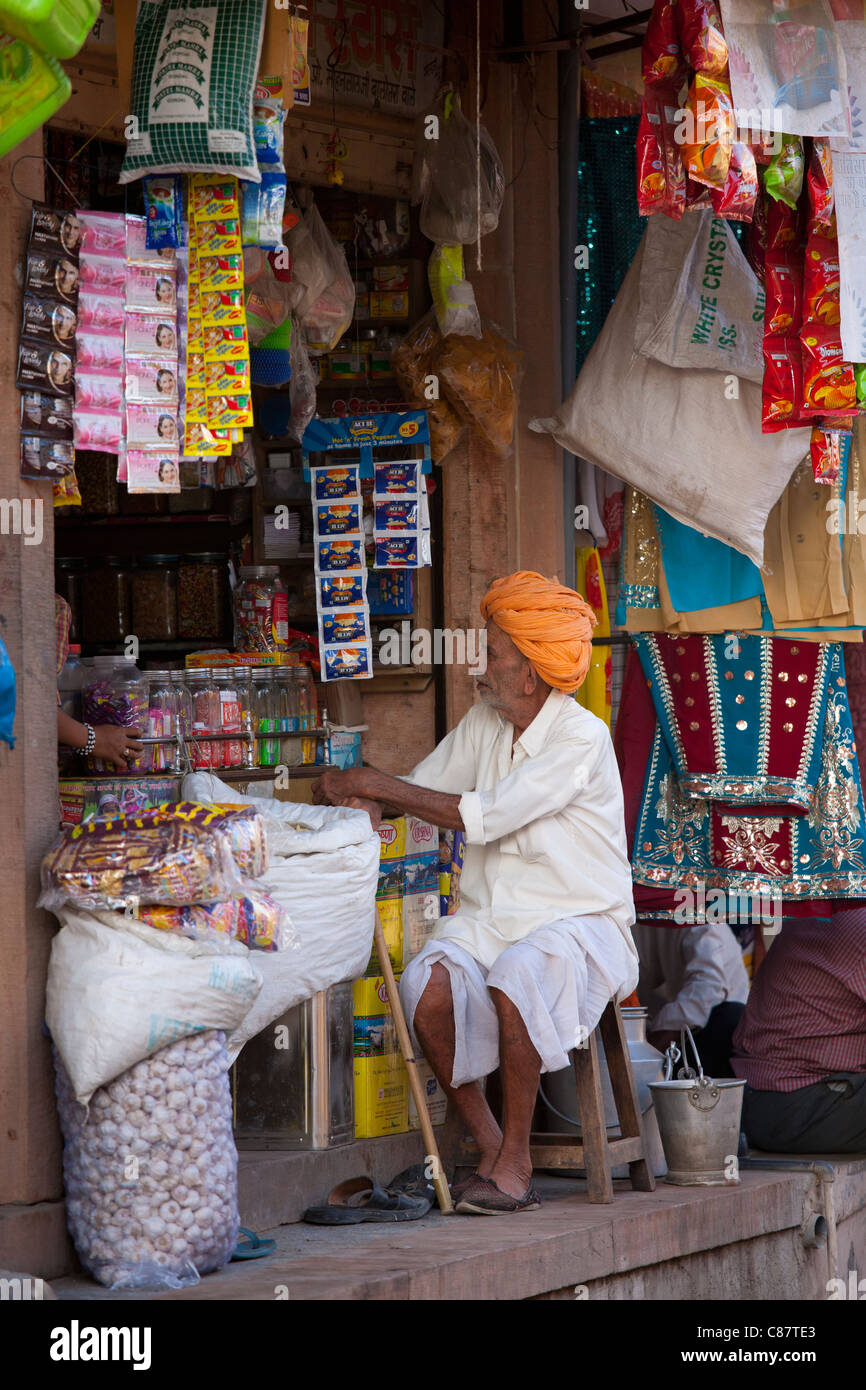 Indian shopkeeper in his food shop and general store in village of ...