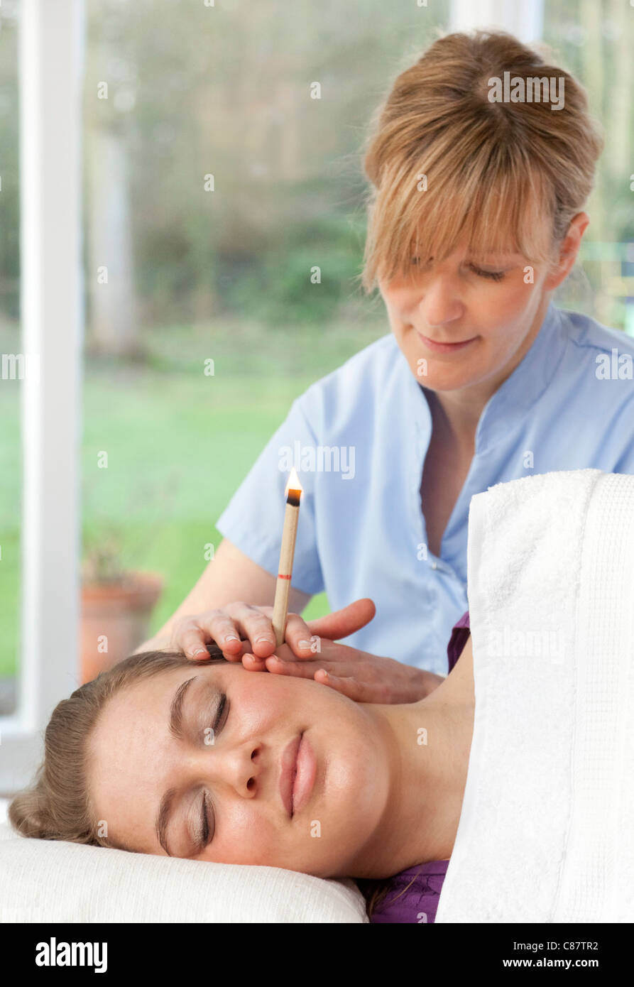 ear candling treatment in the UK Stock Photo - Alamy