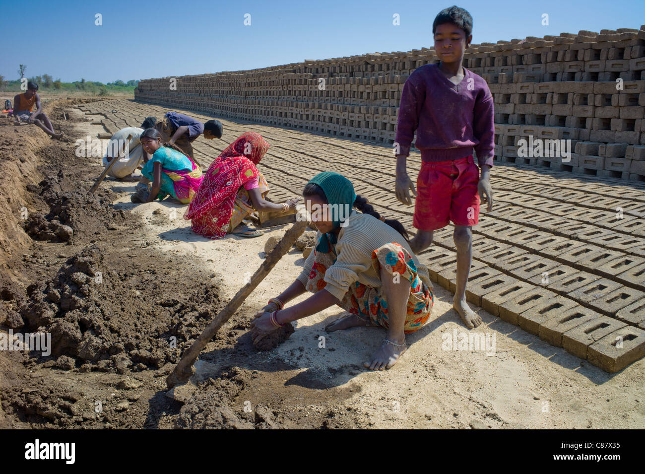 Indian family making bricks made from mud clay at Khore Bricks Factory ...