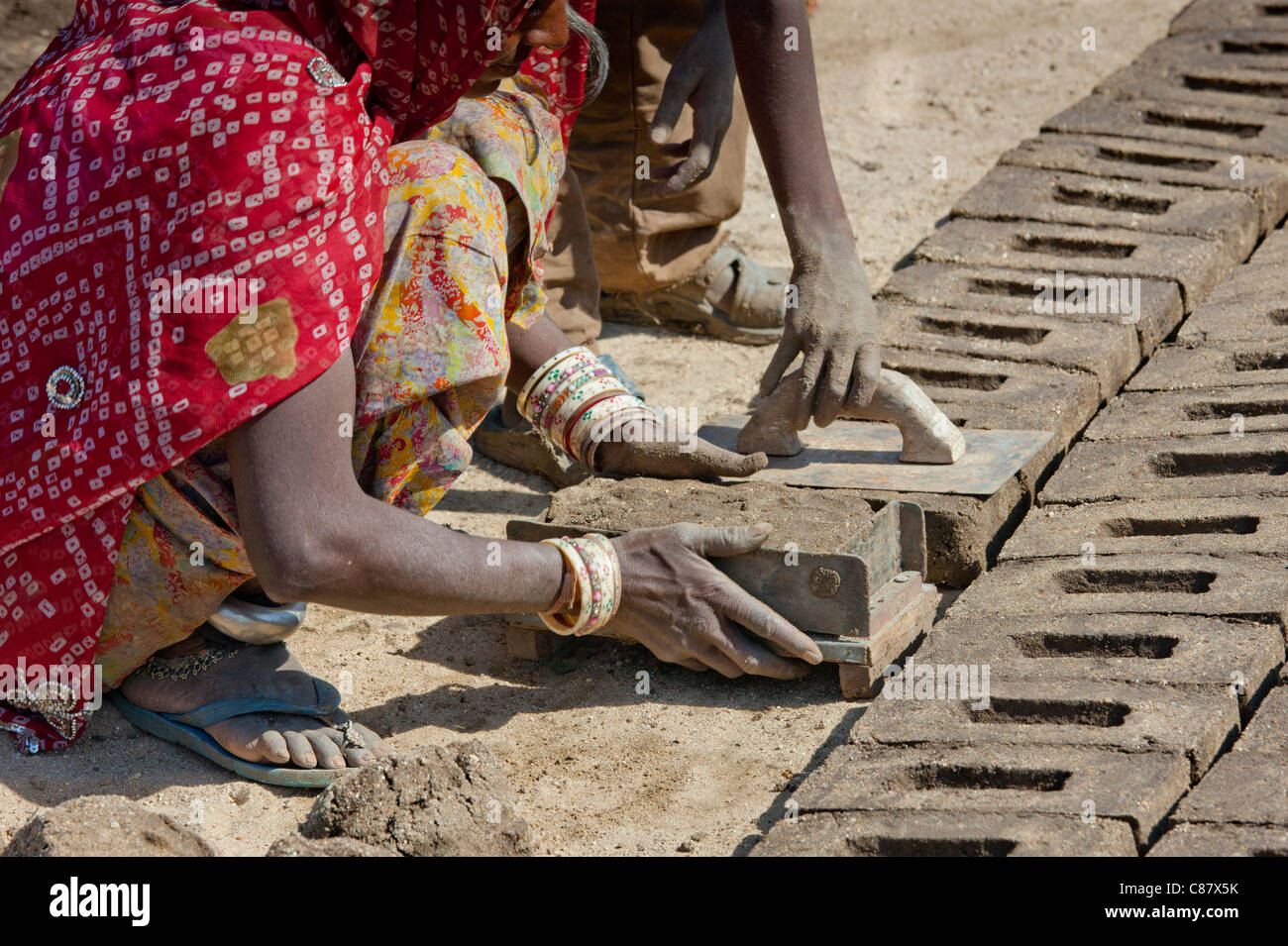 Indian family forming bricks made from mud clay at Khore Bricks Factory ...