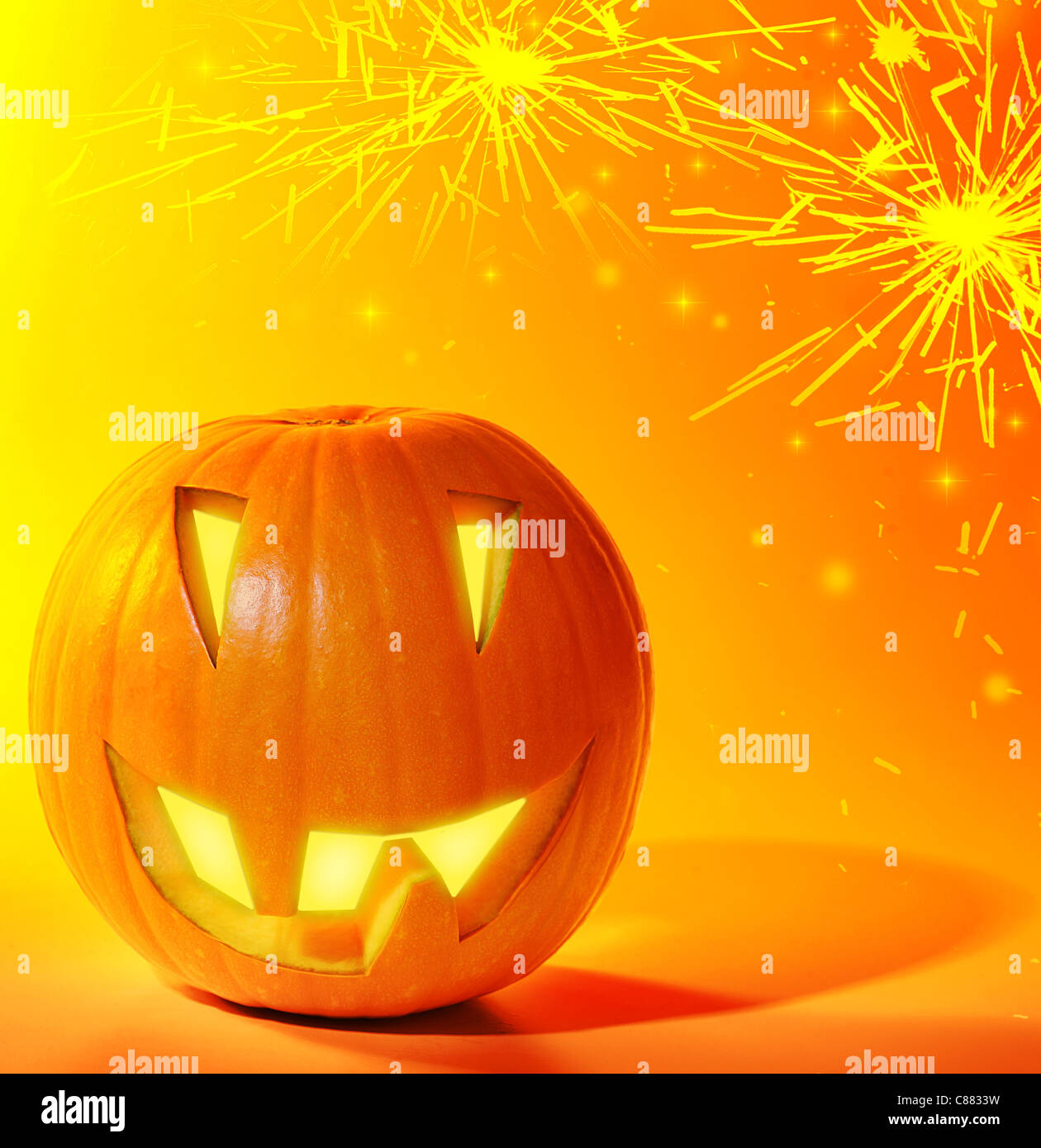 Halloween glowing pumpkins over bright yellow fireworks background ...