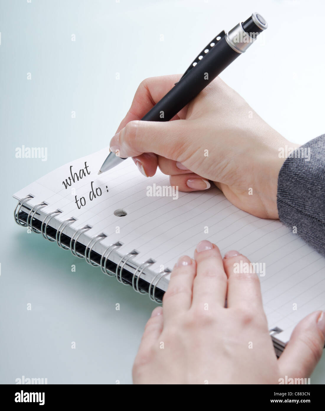 woman's hand with a pen on a notebook Stock Photo - Alamy