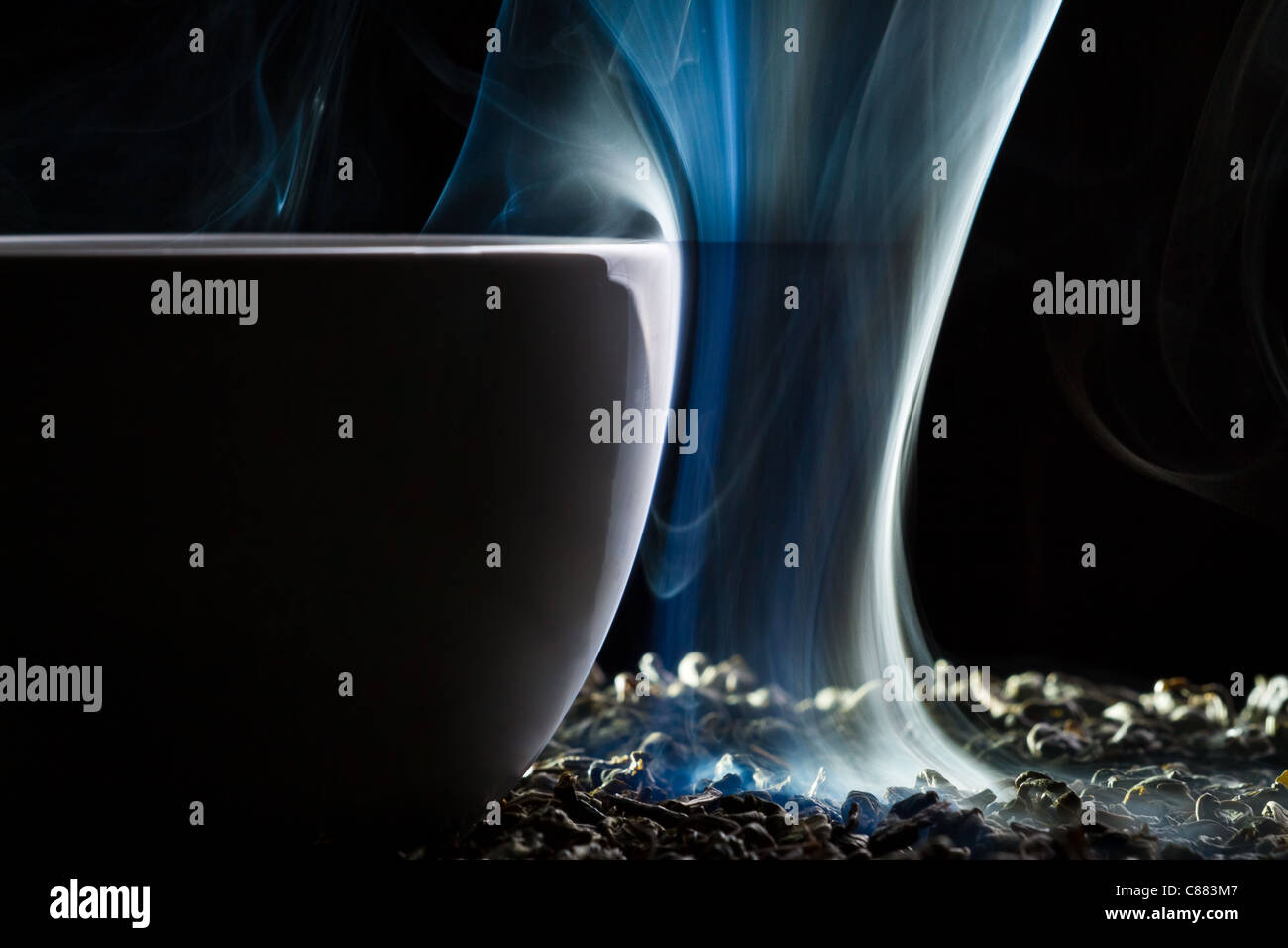 Roasted tea and cup on black background Stock Photo - Alamy