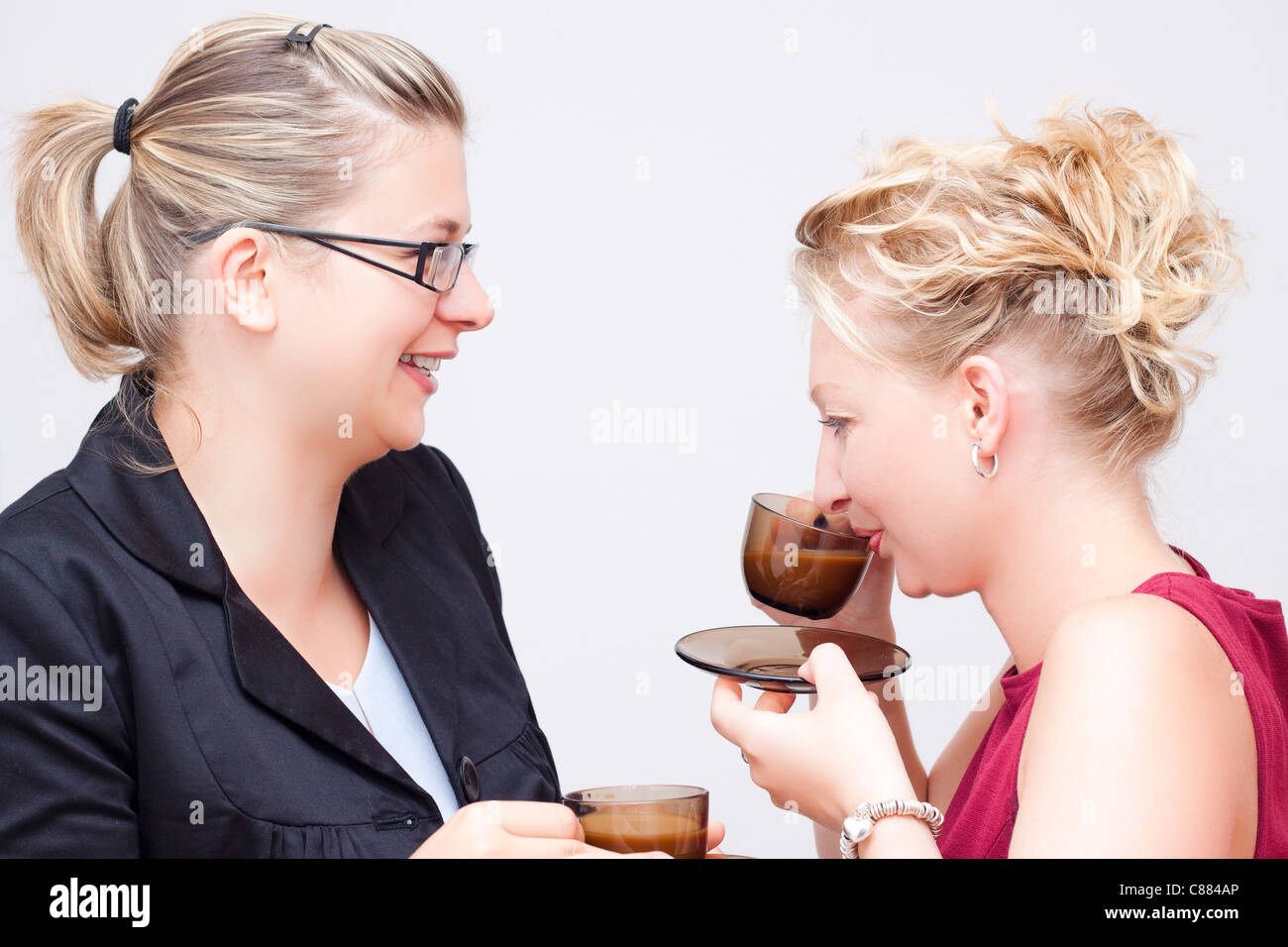 Two young business women having coffee break Stock Photo - Alamy