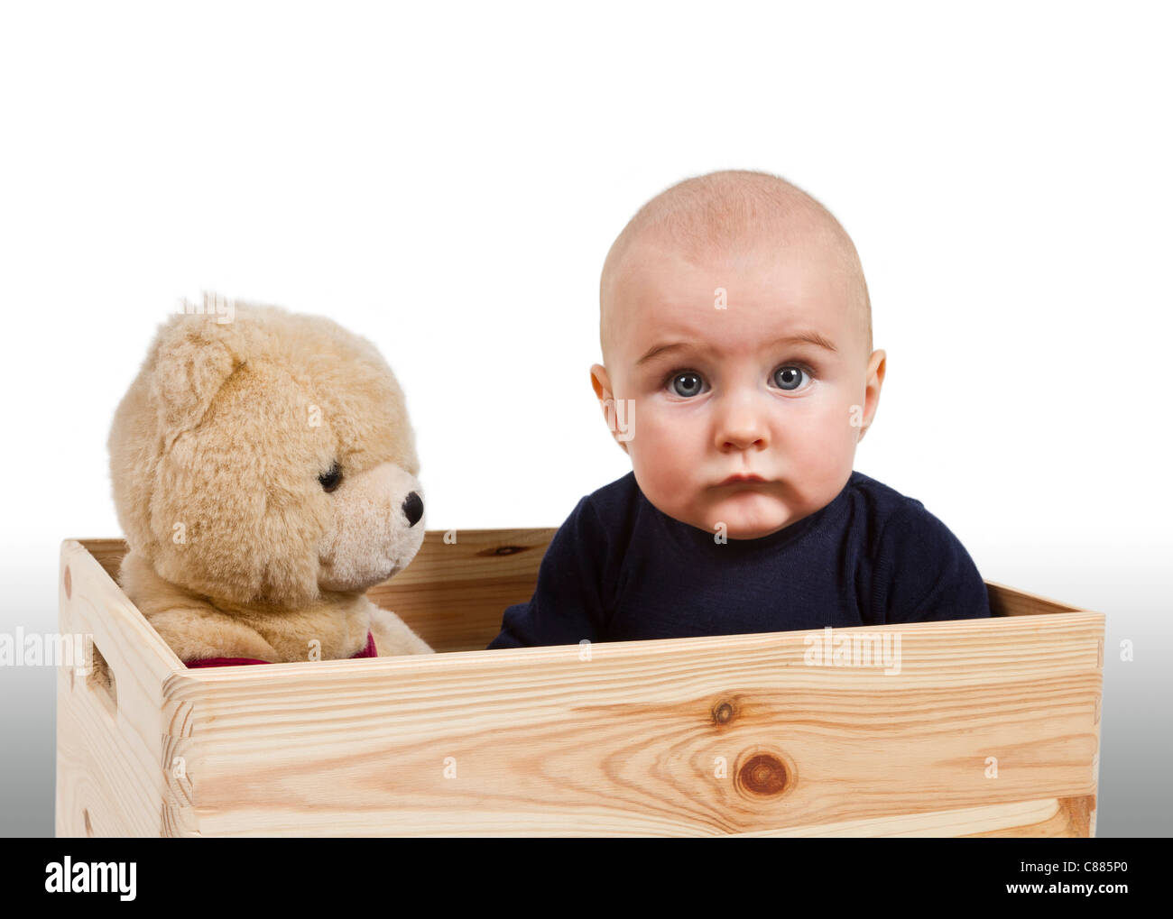 young child with toy in wooden box. white background Stock Photo - Alamy