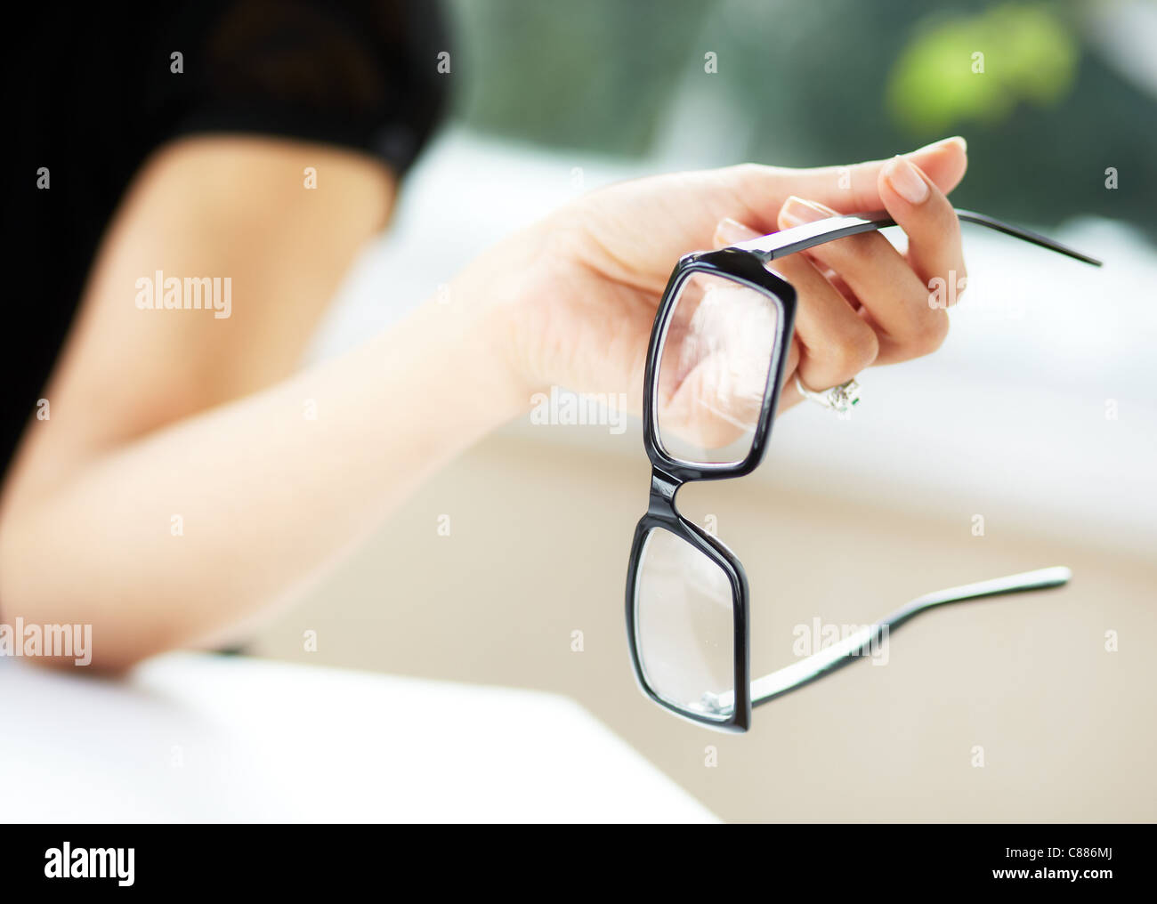 Woman holding glasses Stock Photo - Alamy