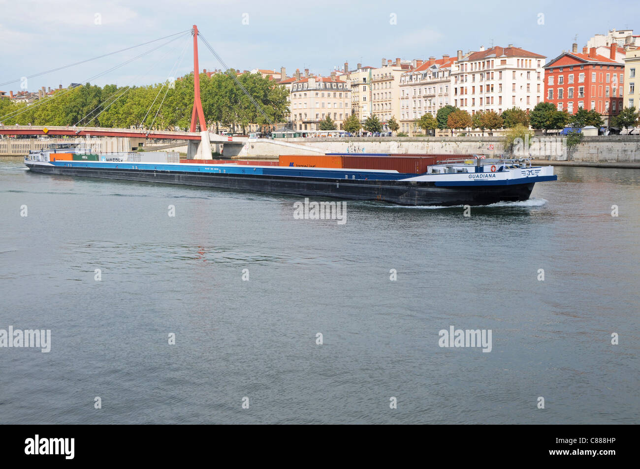 barge on Saone River with Passerelle du Palais de Justice foot bridge ...