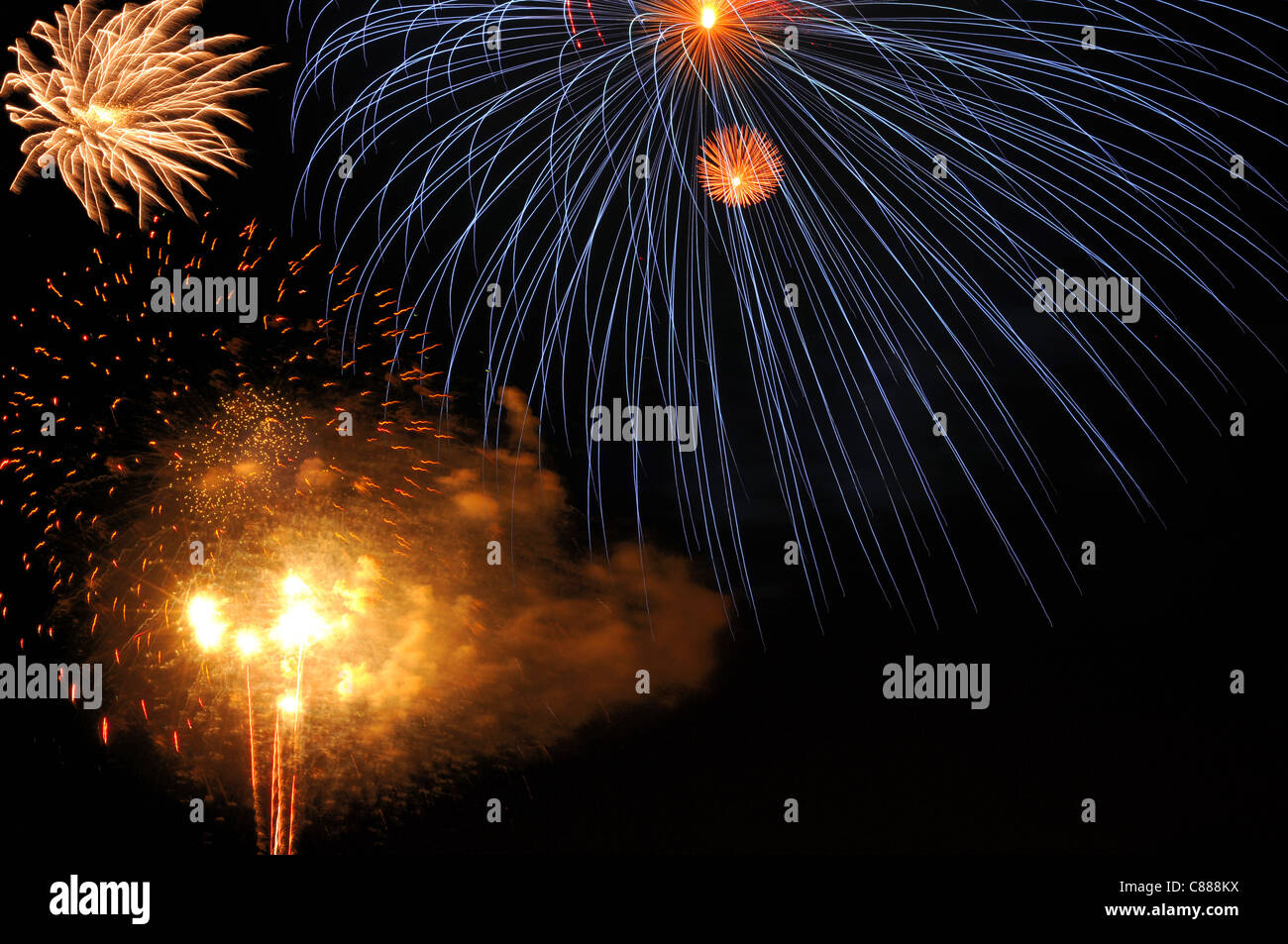 Fireworks with a big blue burst and gold rockets Stock Photo - Alamy