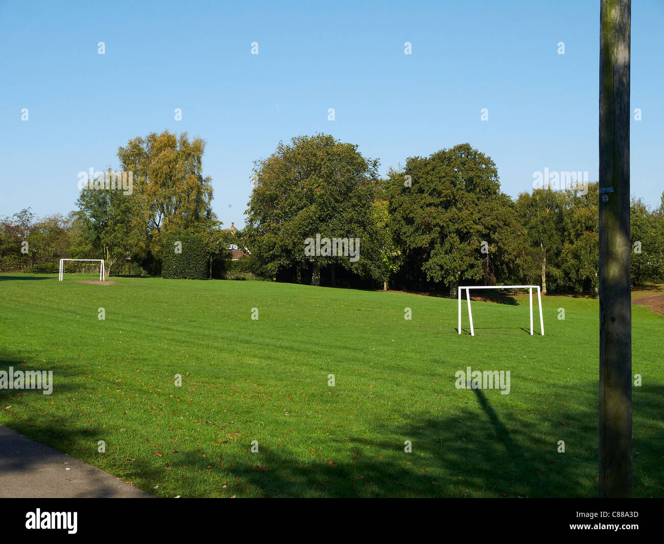 Empty goal post in playing field or park Stock Photo - Alamy