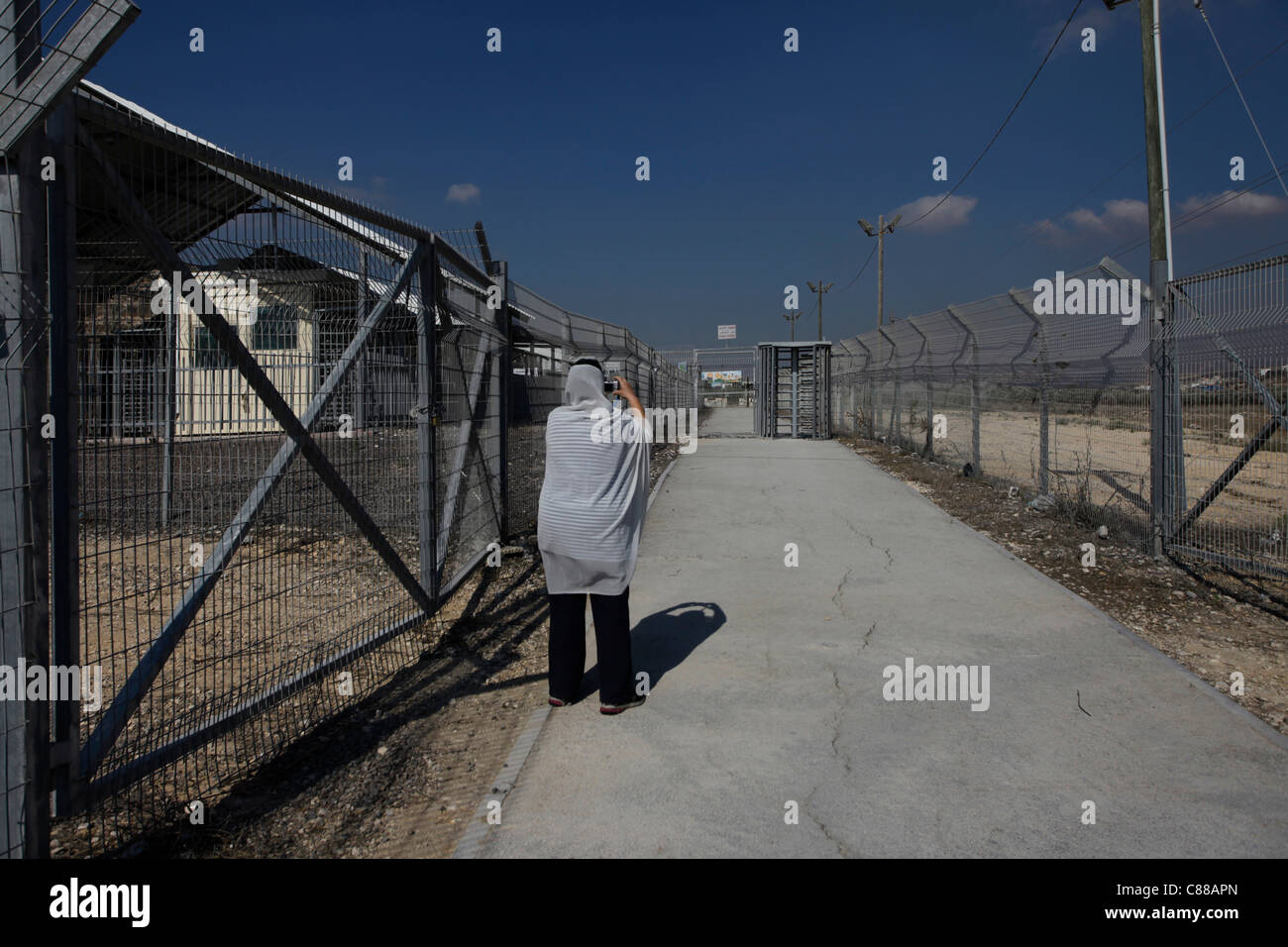 An Israeli woman takes photos of the Huwwara or Huwara checkpoint ...