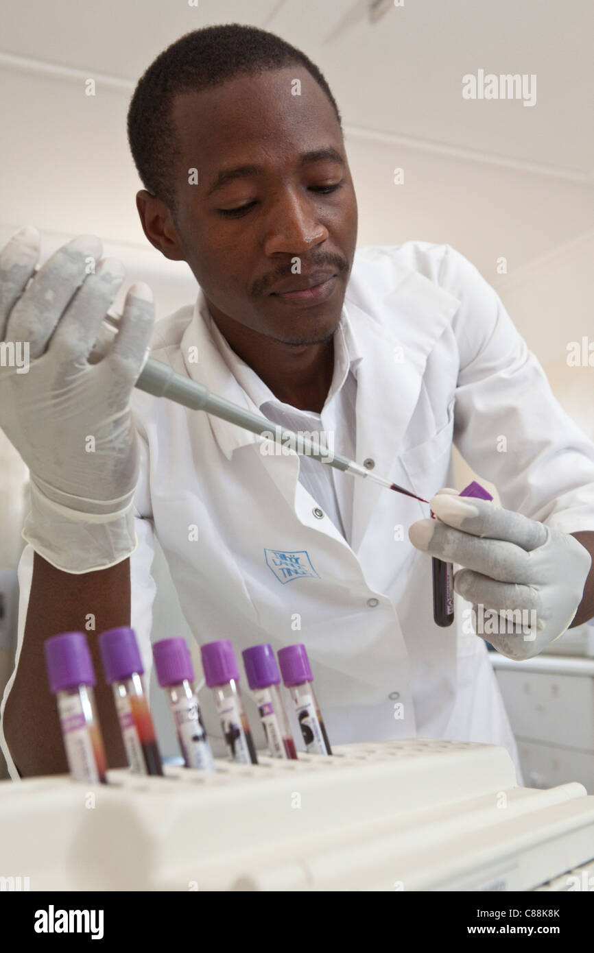 Technician in white lab coat testing patient hi-res stock photography ...