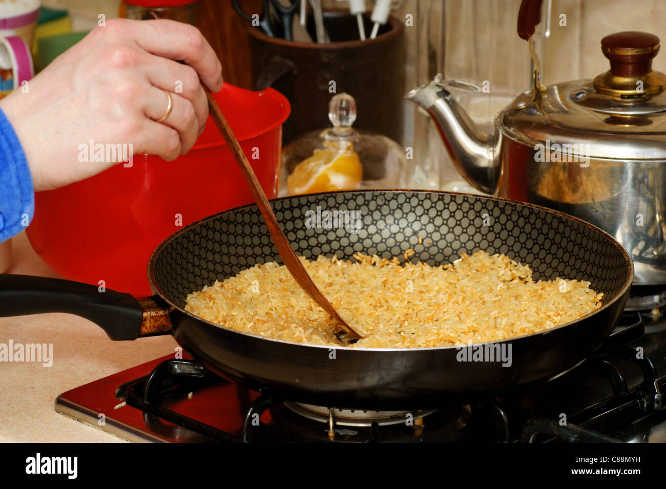 rice on frying pan, skillet, wood spoon Stock Photo - Alamy