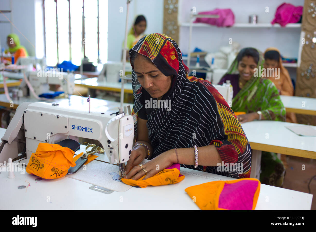 Indian women sewing textiles at Dastkar women's craft co-operative, the ...