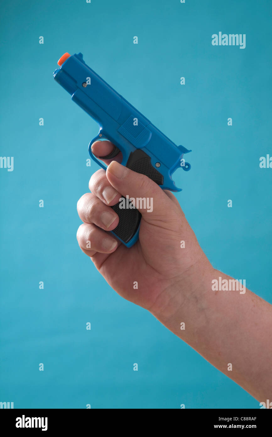 Man holding a toy gun Stock Photo - Alamy