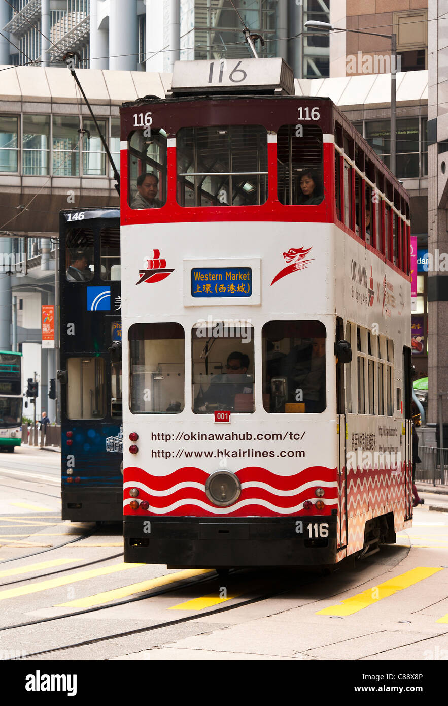 Brightly Coloured Public Trams Running Along Des Voeux Road Central ...