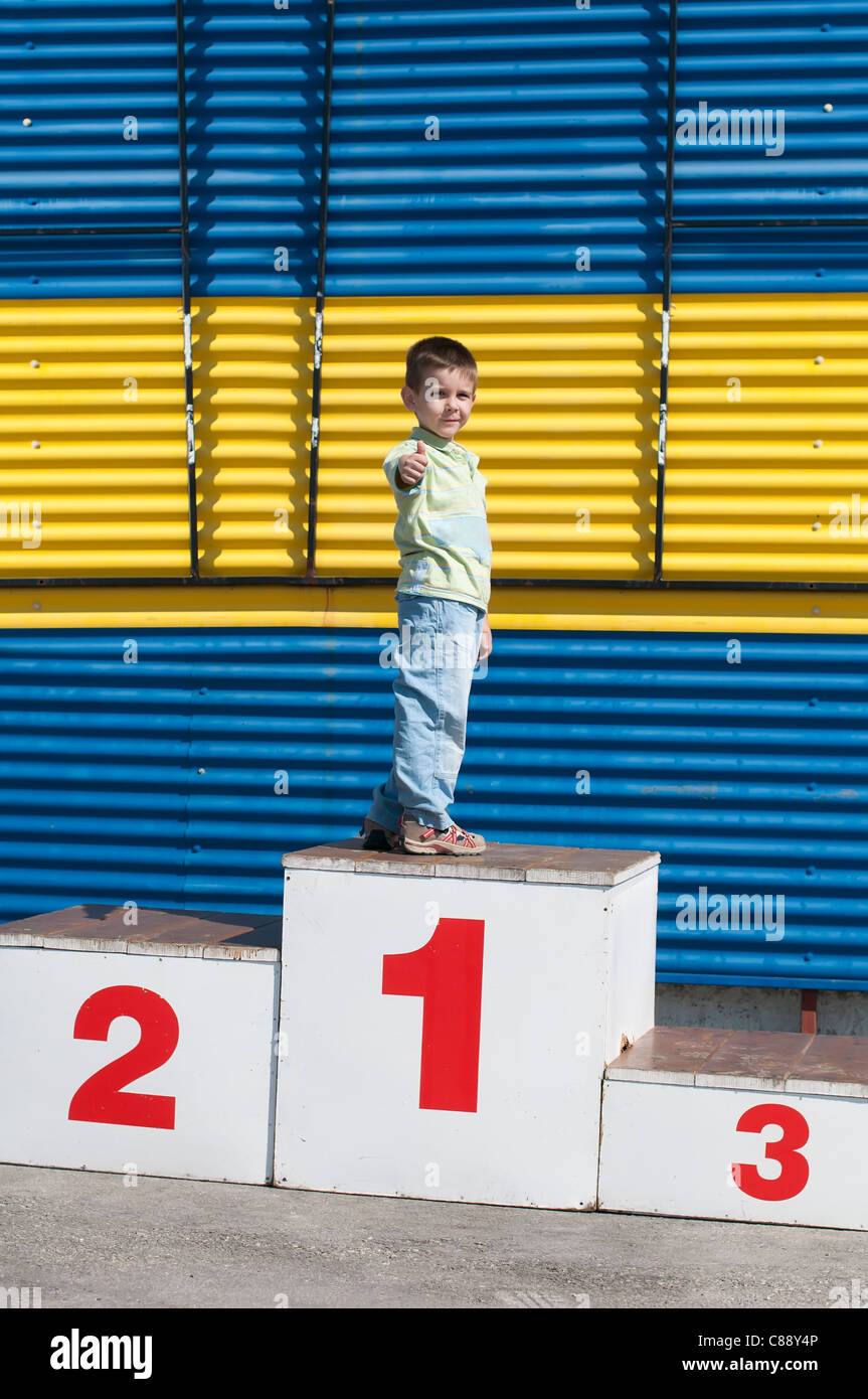 Little boy on the podium. First place Stock Photo - Alamy