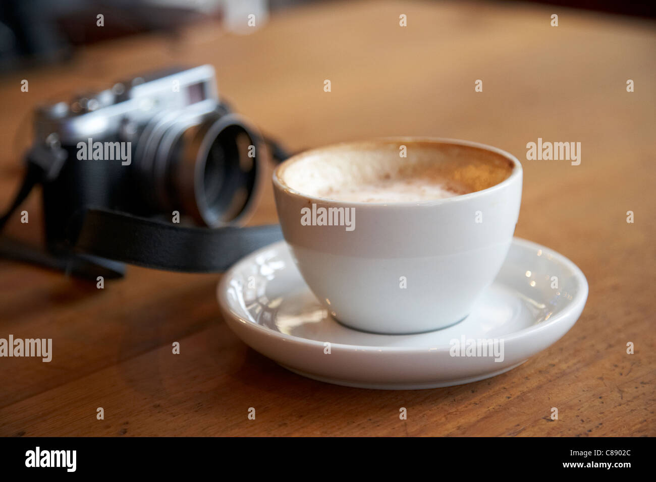 cup of coffee and a camera on a wooden coffee shop table belfast city ...