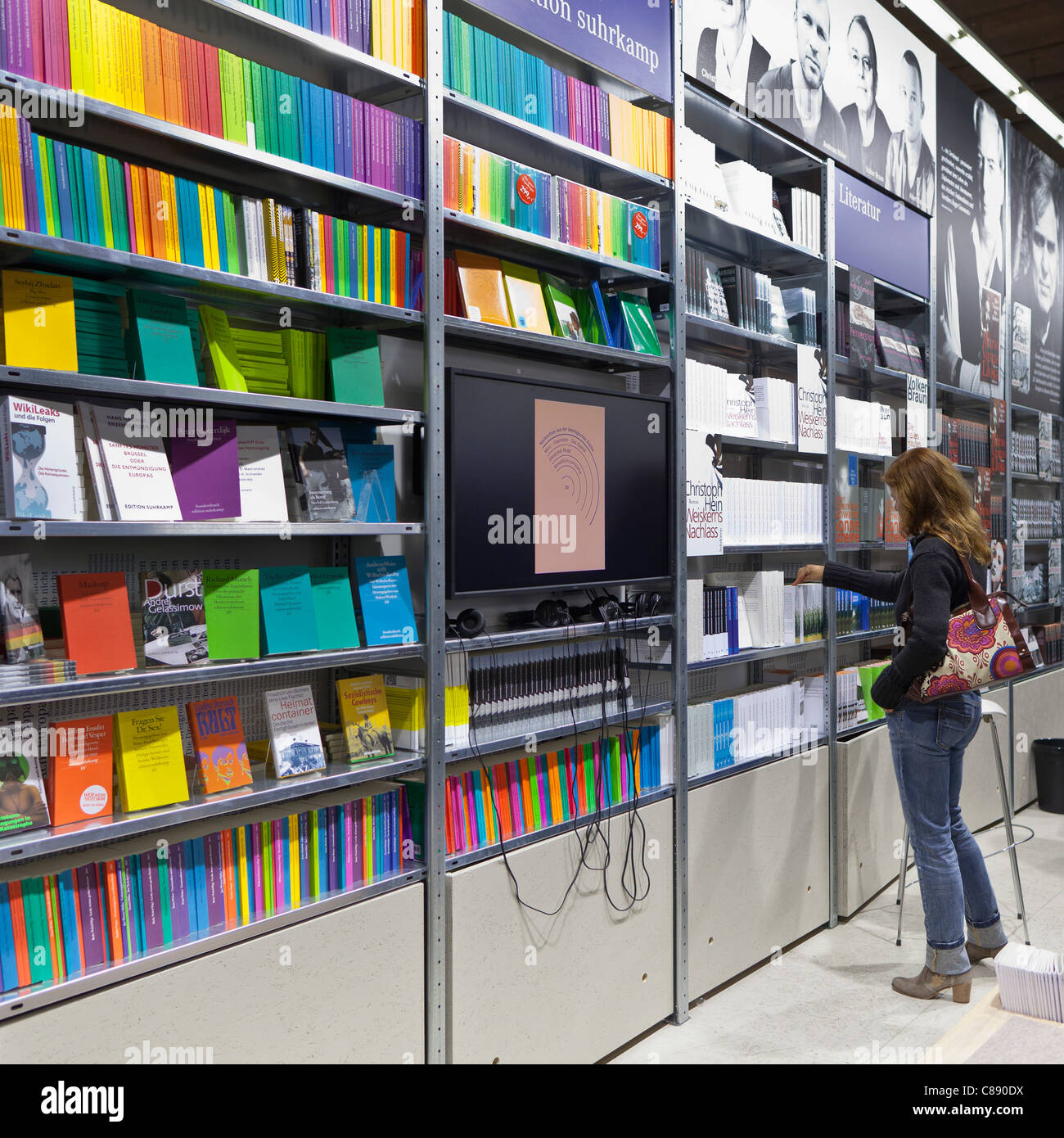 Visitor reading book at publisher booth at the international Frankfurt ...
