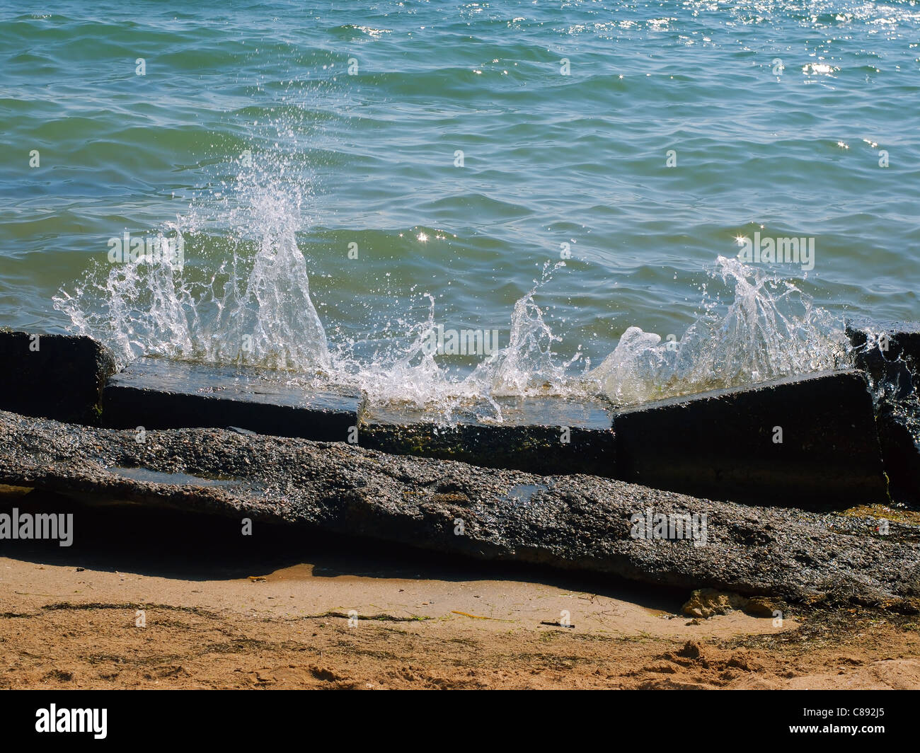 splash of sea drops on beach Stock Photo - Alamy